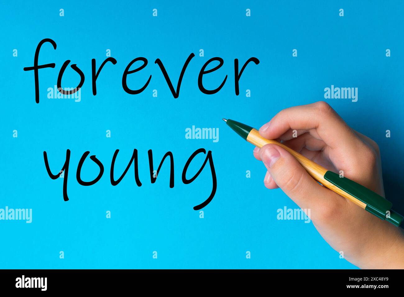 Children hand with pen write on an blue white background. Writing hand ...