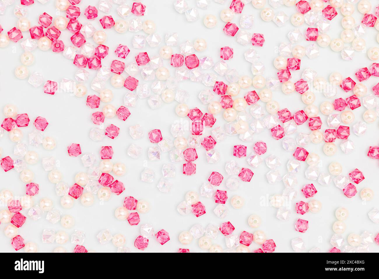 Texture made from shiny acrylic beads scattered on a blue background ...