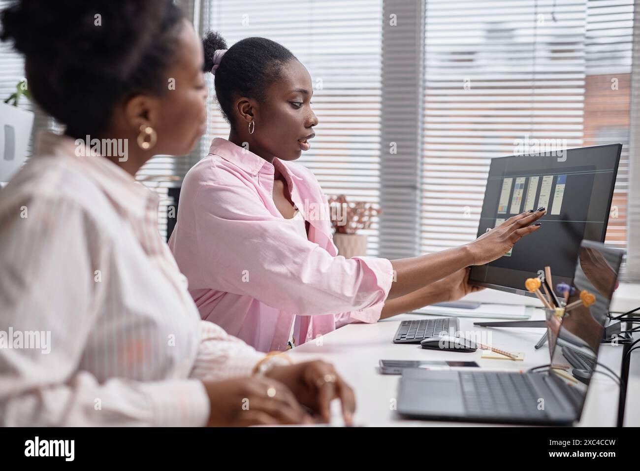 Side view portrait of female developer showing online project results ...