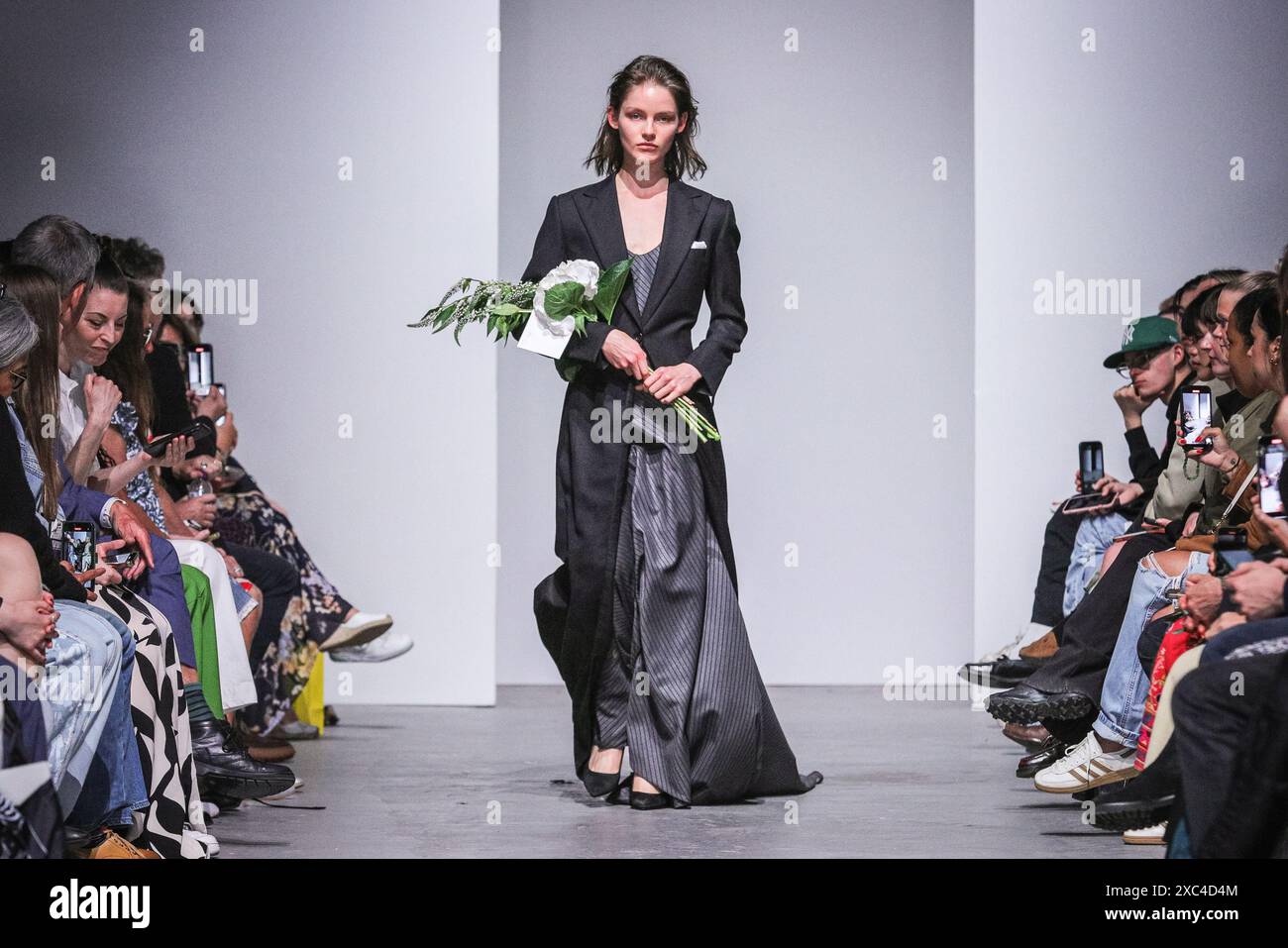 London, UK. 14th June, 2024. Models on the runway present the designs ...