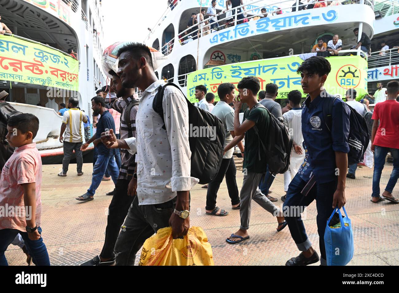 Passengers gather at the launch terminal for ferries as they travel ...