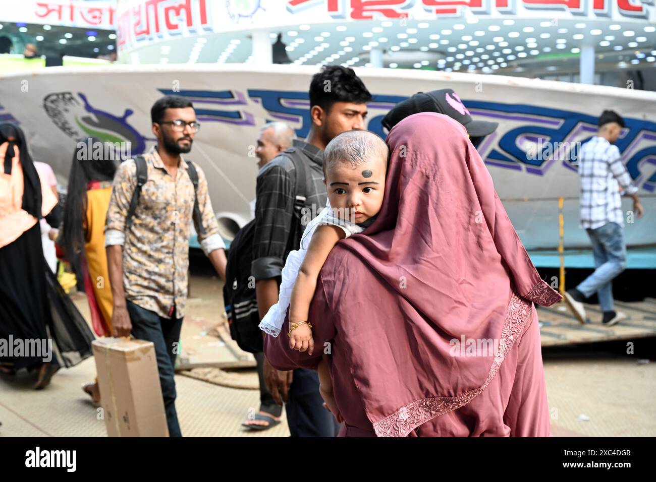 Passengers gather at the launch terminal for ferries as they travel back to their villages from ...