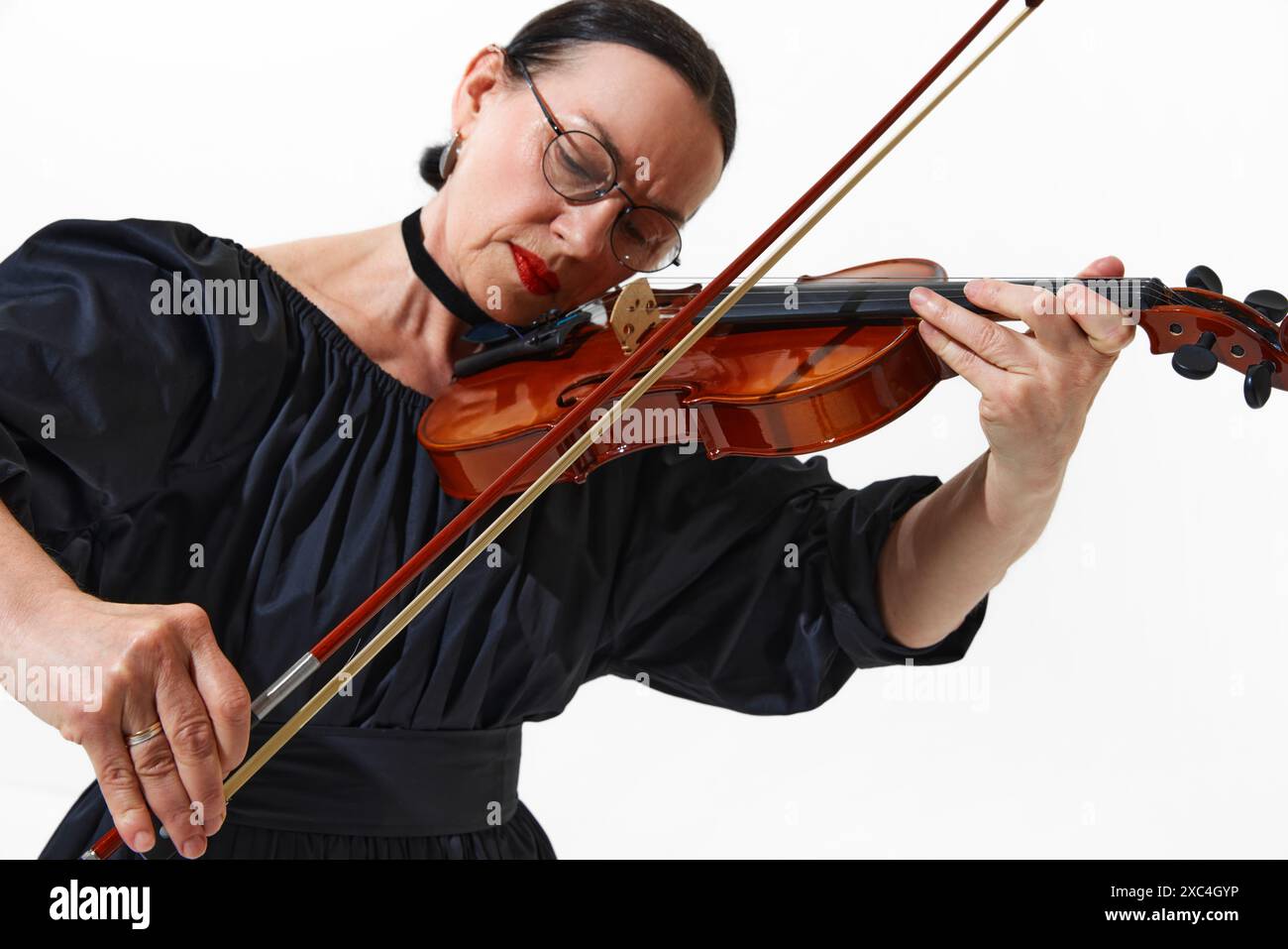Woman, violin player performs a complex composition, engaging deeply ...