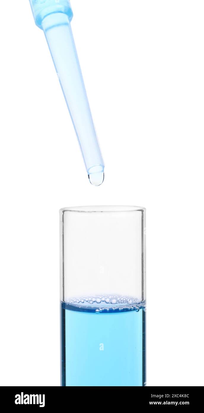 Dripping liquid from pipette into test tube isolated on white, closeup ...
