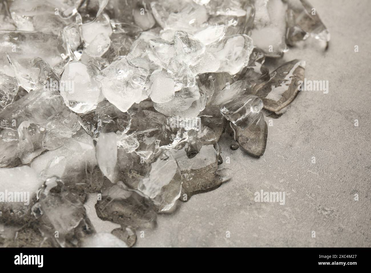 Pile of crushed ice on dark textured table, above view Stock Photo - Alamy