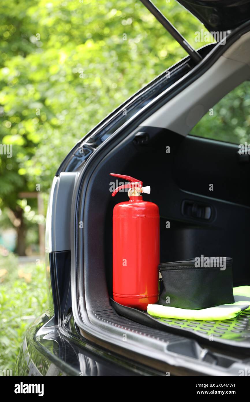 Red fire extinguisher in trunk. Car safety equipment Stock Photo - Alamy
