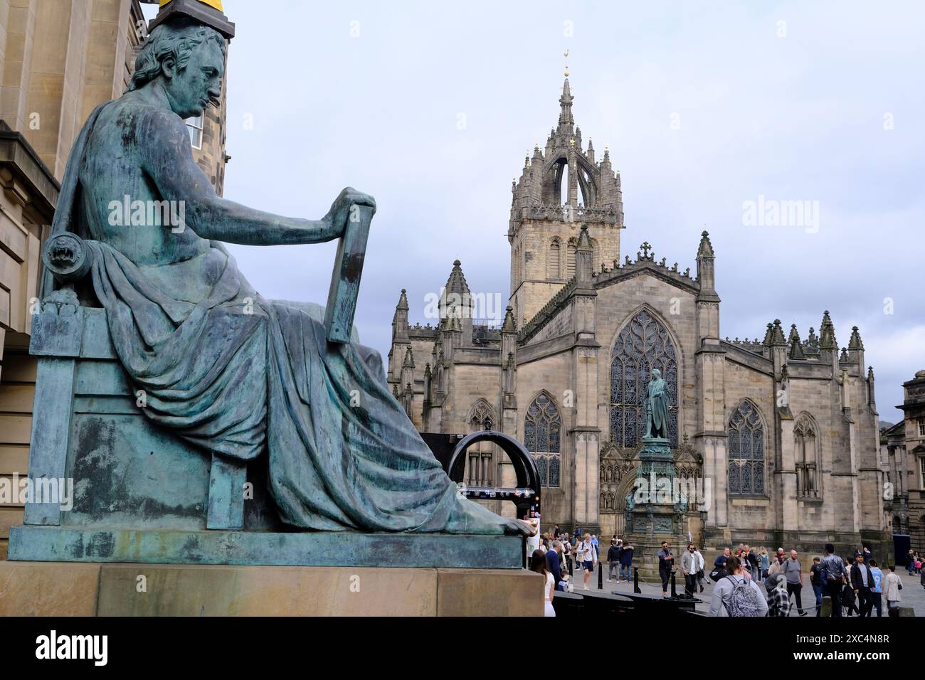 The statue of Scottish philosopher David Hume with St.Giles' Cathedral ...