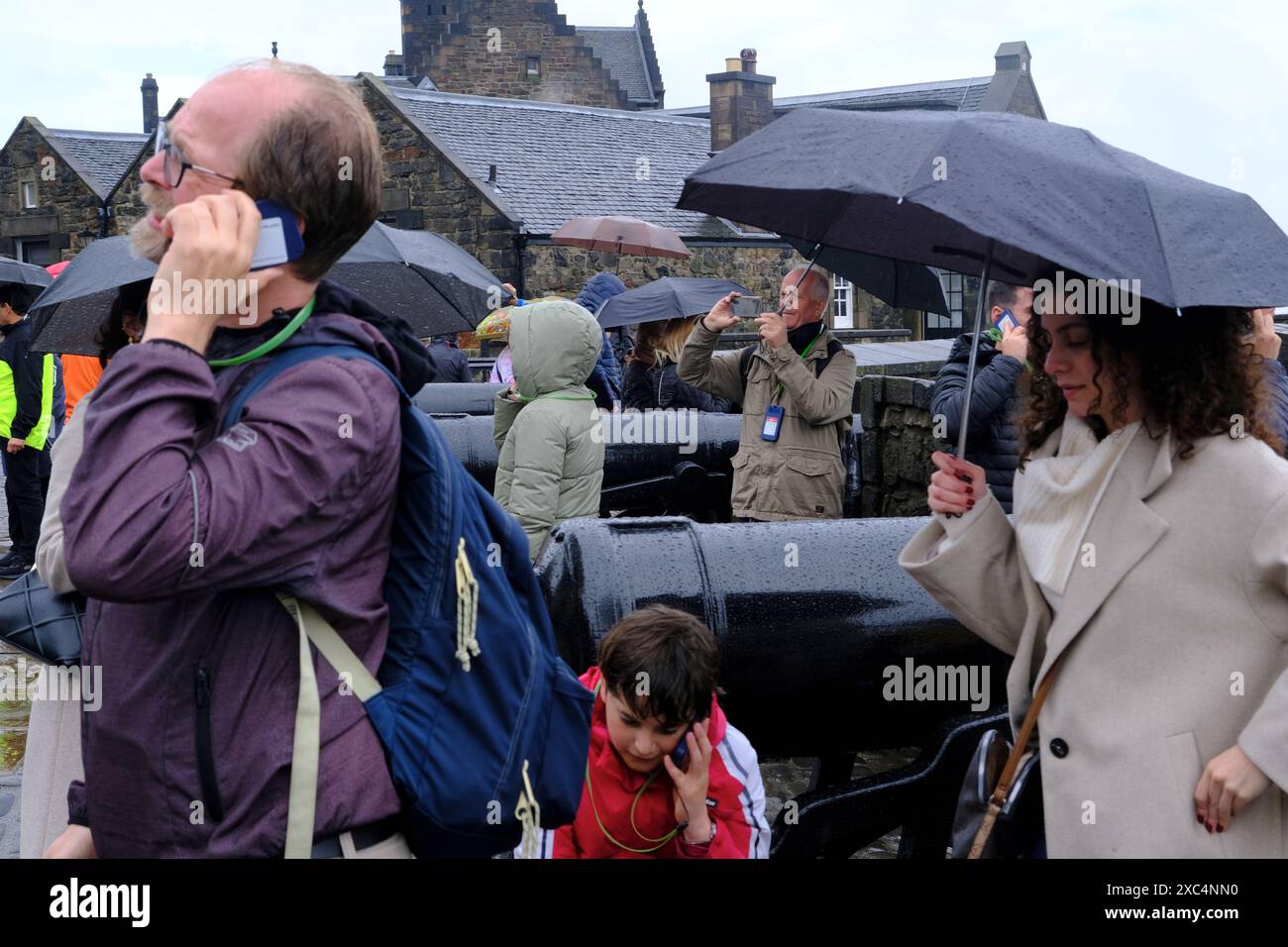 Tourists on their audio guide during the tour of Edinburgh Castle in a ...