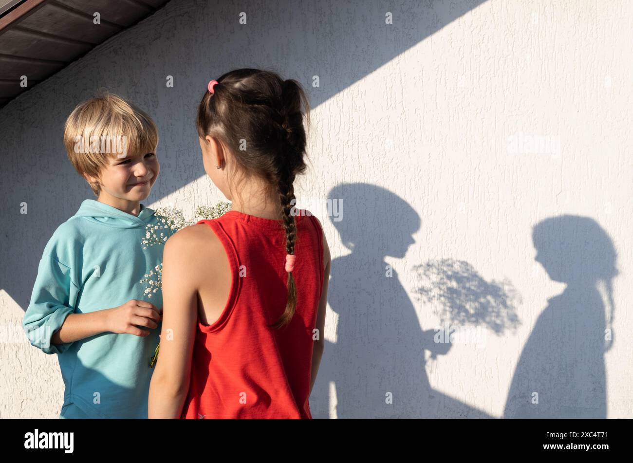 children and their contrasting shadows on wall on sunny day Stock Photo ...
