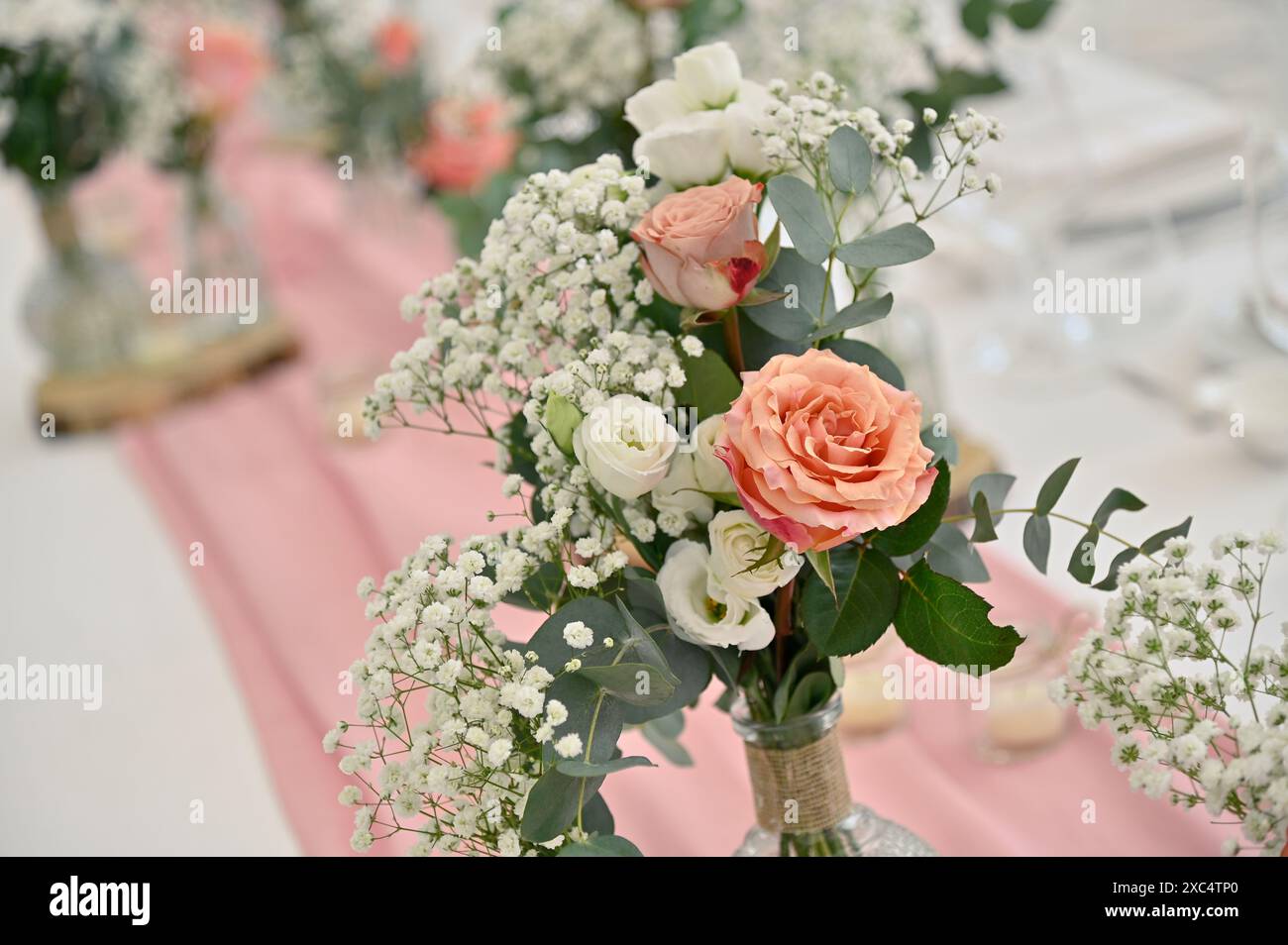 An elegant centerpiece with peach roses and white flowers, ideal for ...