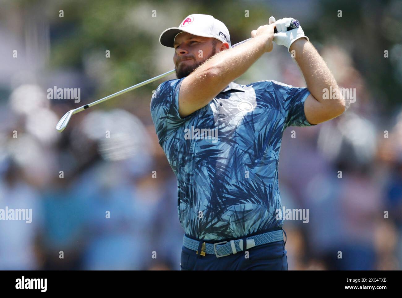 Tyrrell Hatton of England hits an approach shot to sixteenth green ...