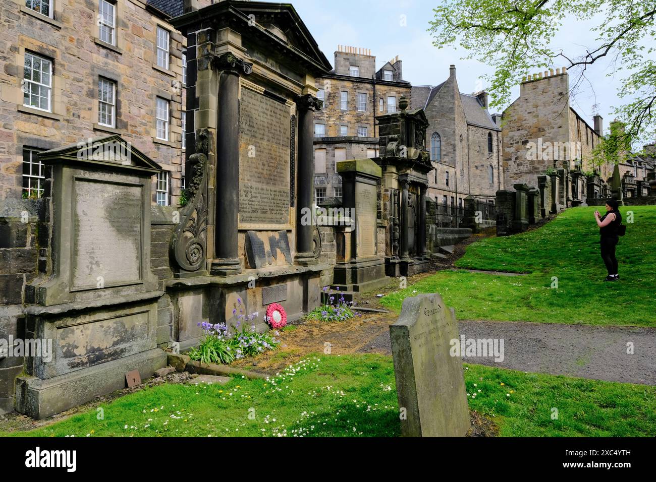 Old tombs and graves in Greyfriars Kinkyard with the buildings of Old ...