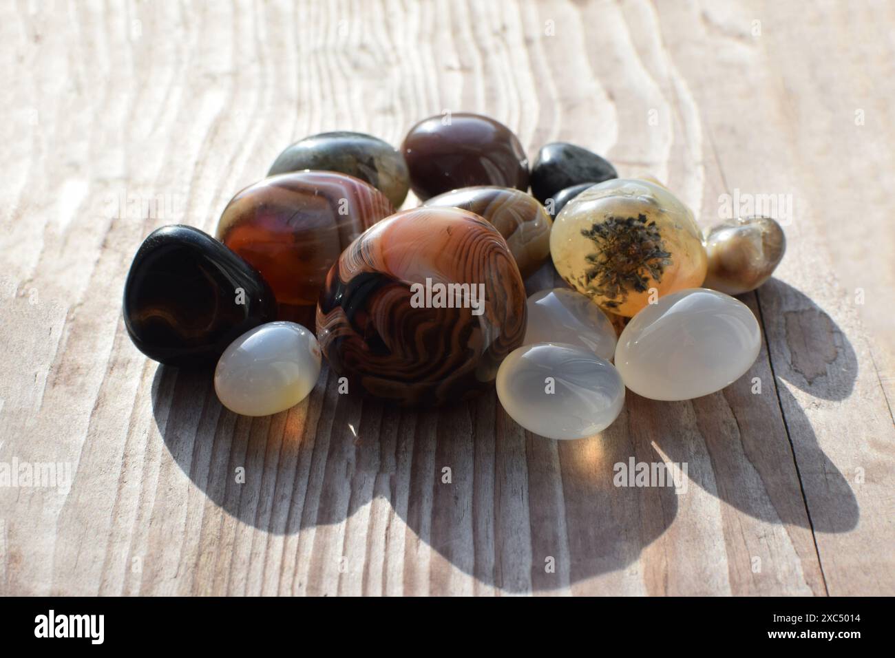 Healing crystals on an old wooden background. Botswana agate. Multi ...