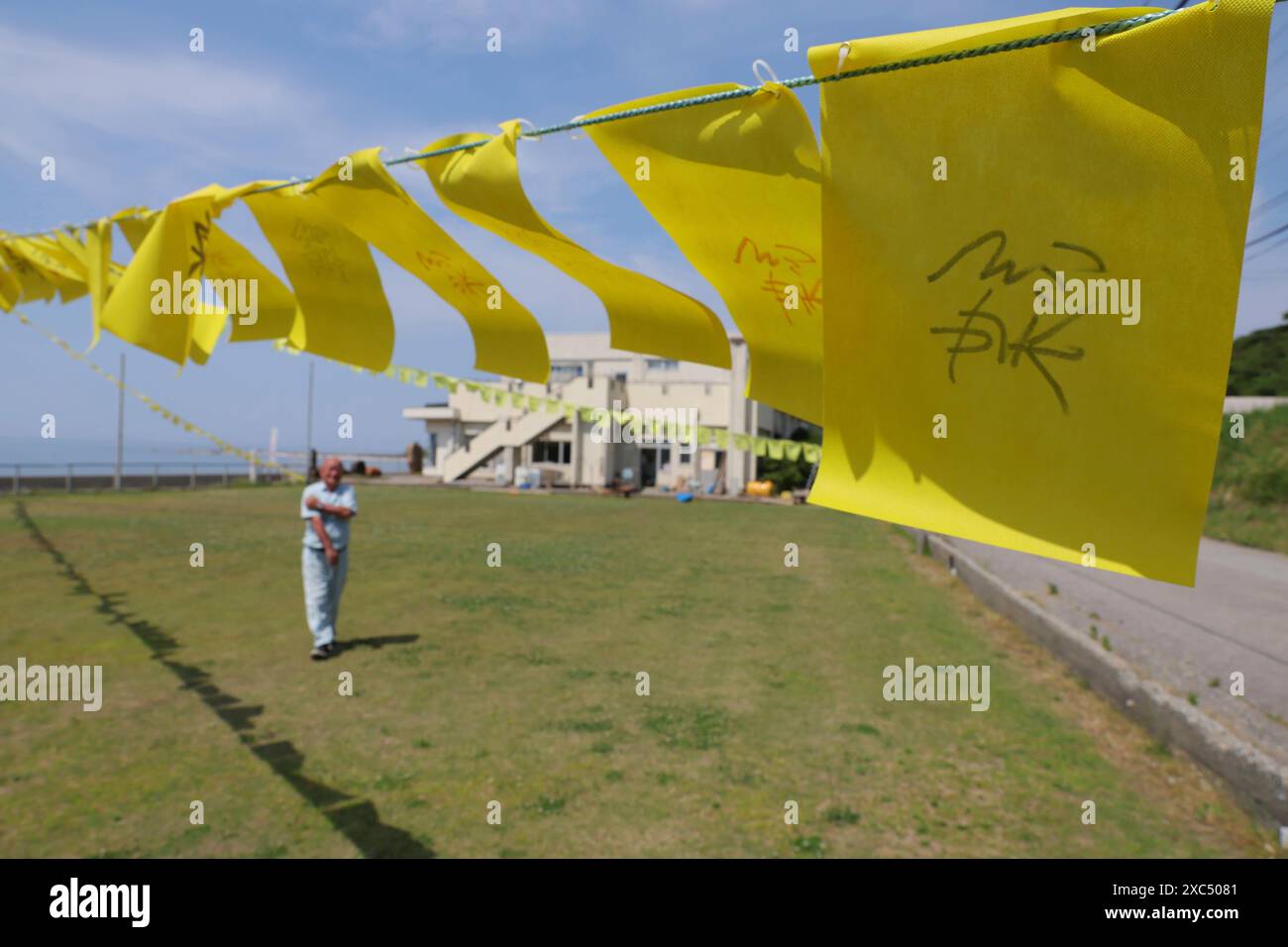 Around 300 pieces of yellow cloth are hung at a facility for voluntary ...