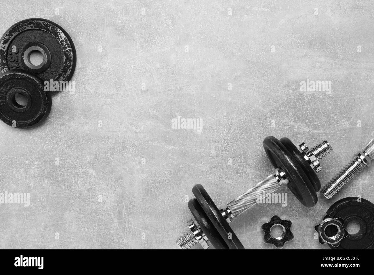 Barbell and parts of one on grey textured background, flat lay. Space ...
