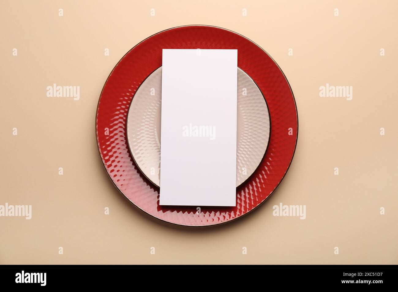 Empty menu and plates on beige background, top view. Mockup for design ...