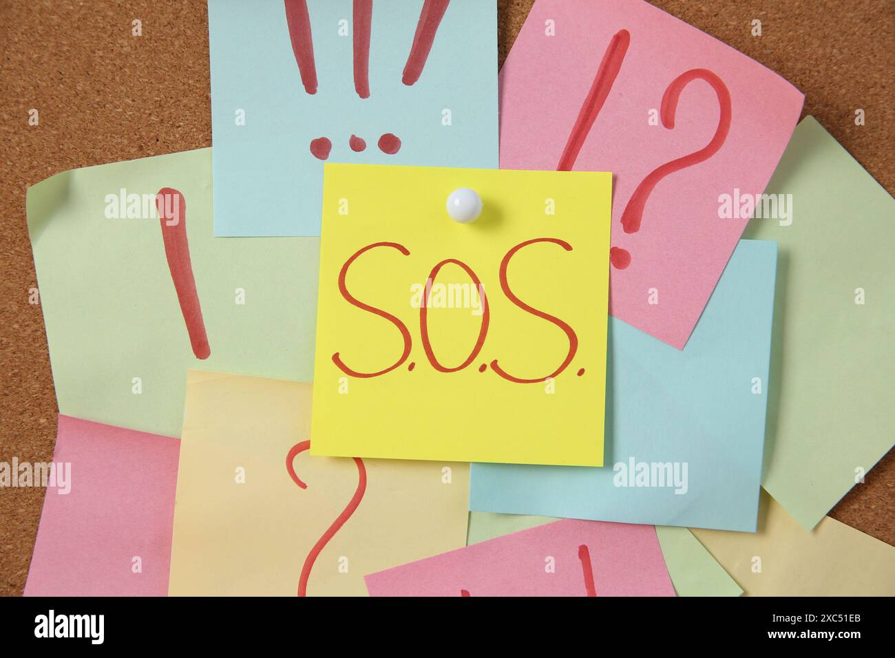 Notes with word SOS and symbols on cork board, closeup Stock Photo - Alamy