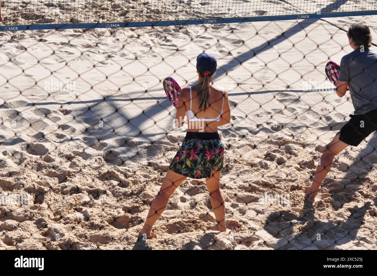Athletes playing in beach tennis competition Stock Photo - Alamy