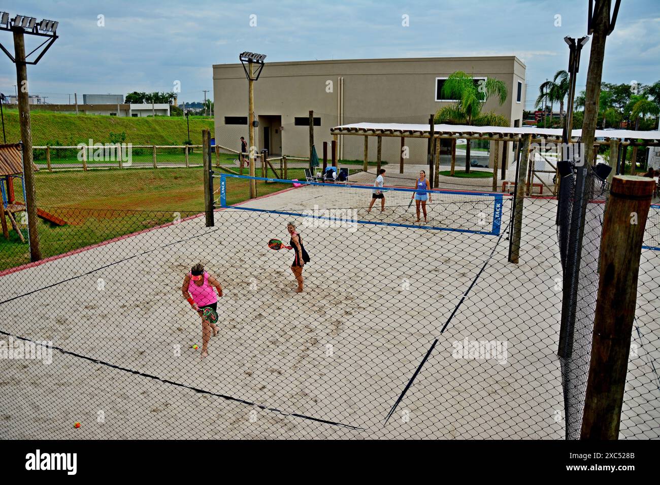 Athletes playing in beach tennis competition Stock Photo - Alamy
