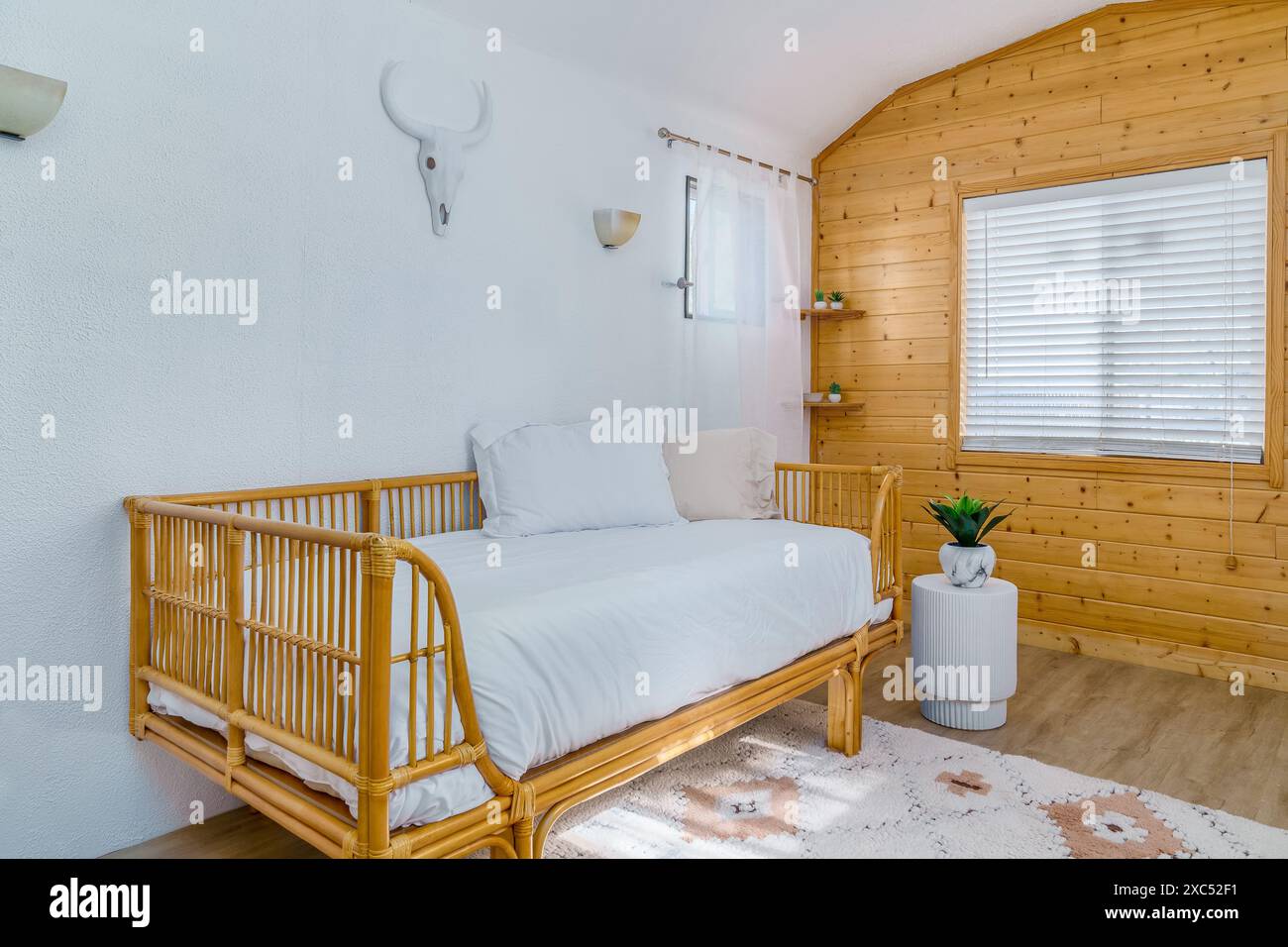 Rattan daybed boho cabin bungalow casita knotty pine paneling Stock ...