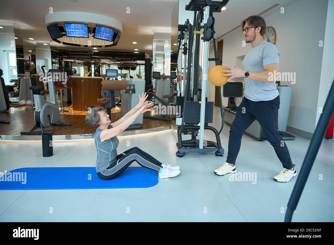 Patient performs exercises with a ball in a gym Stock Photo - Alamy