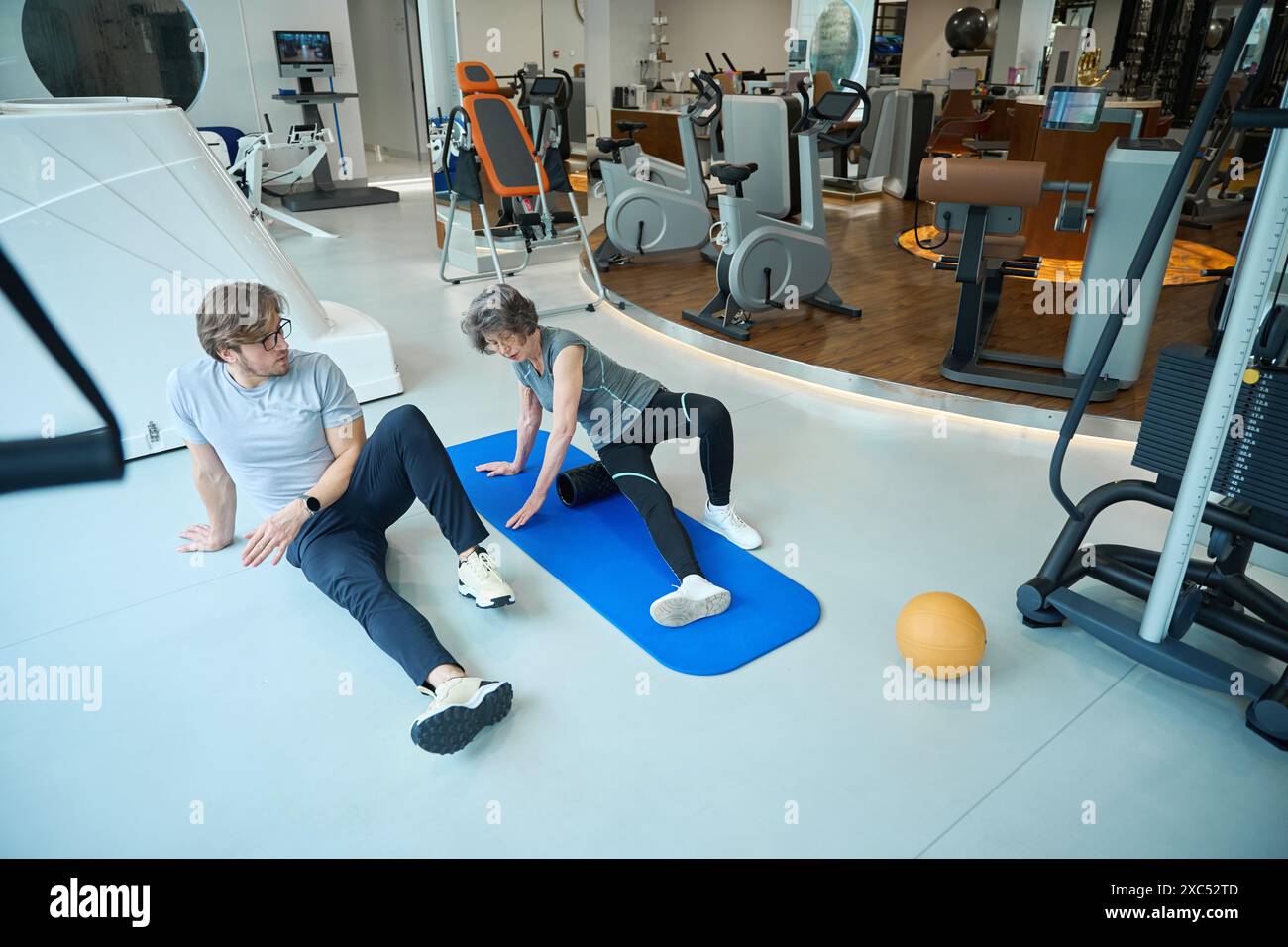 Female patient performs exercises in a gym on a carimate Stock Photo ...