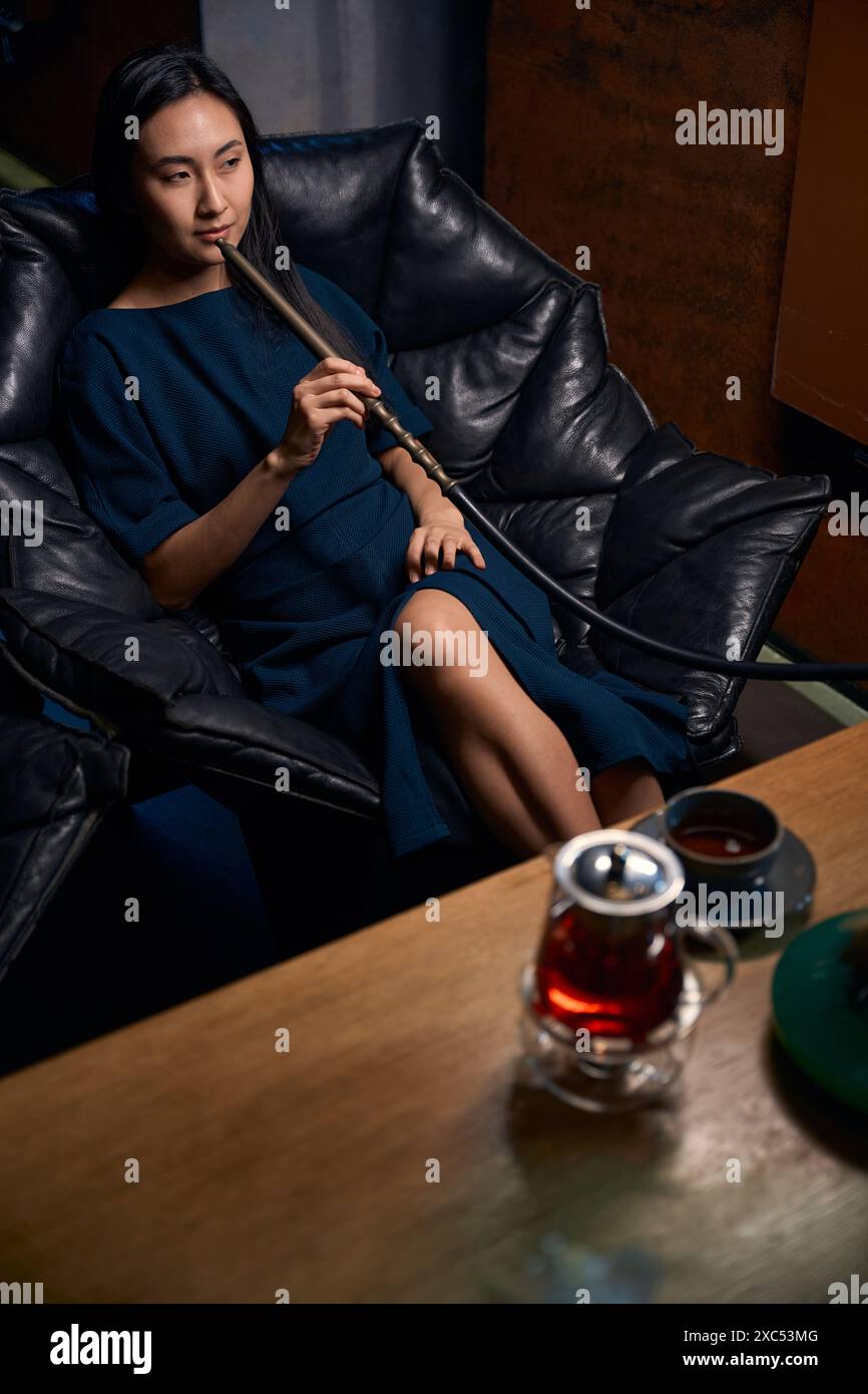 Smoking girl in leather hi-res stock photography and images - Alamy