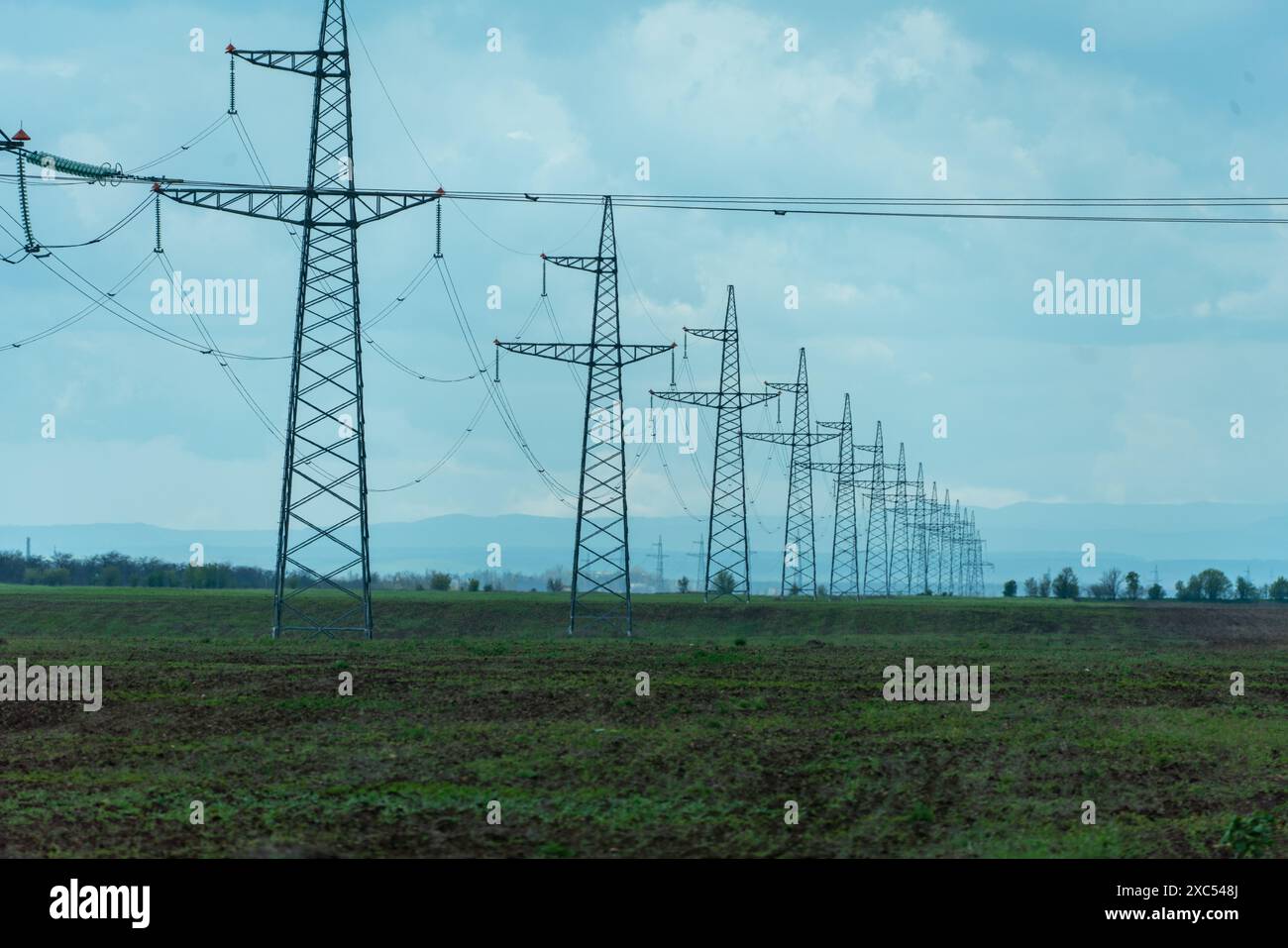 High voltage towers with sky background. Power line support with wires ...