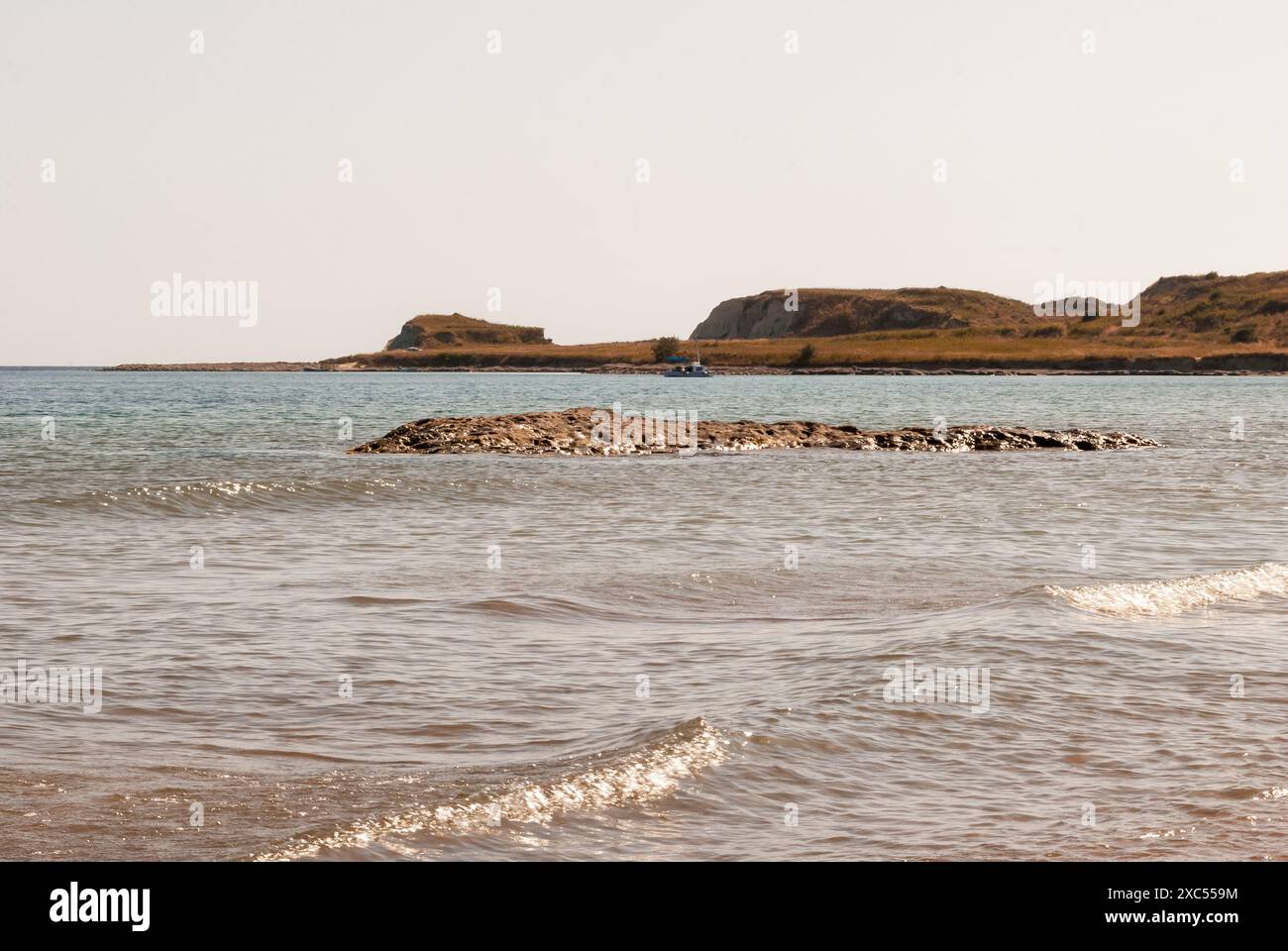 Waves sea against rock sunset hi-res stock photography and images - Alamy