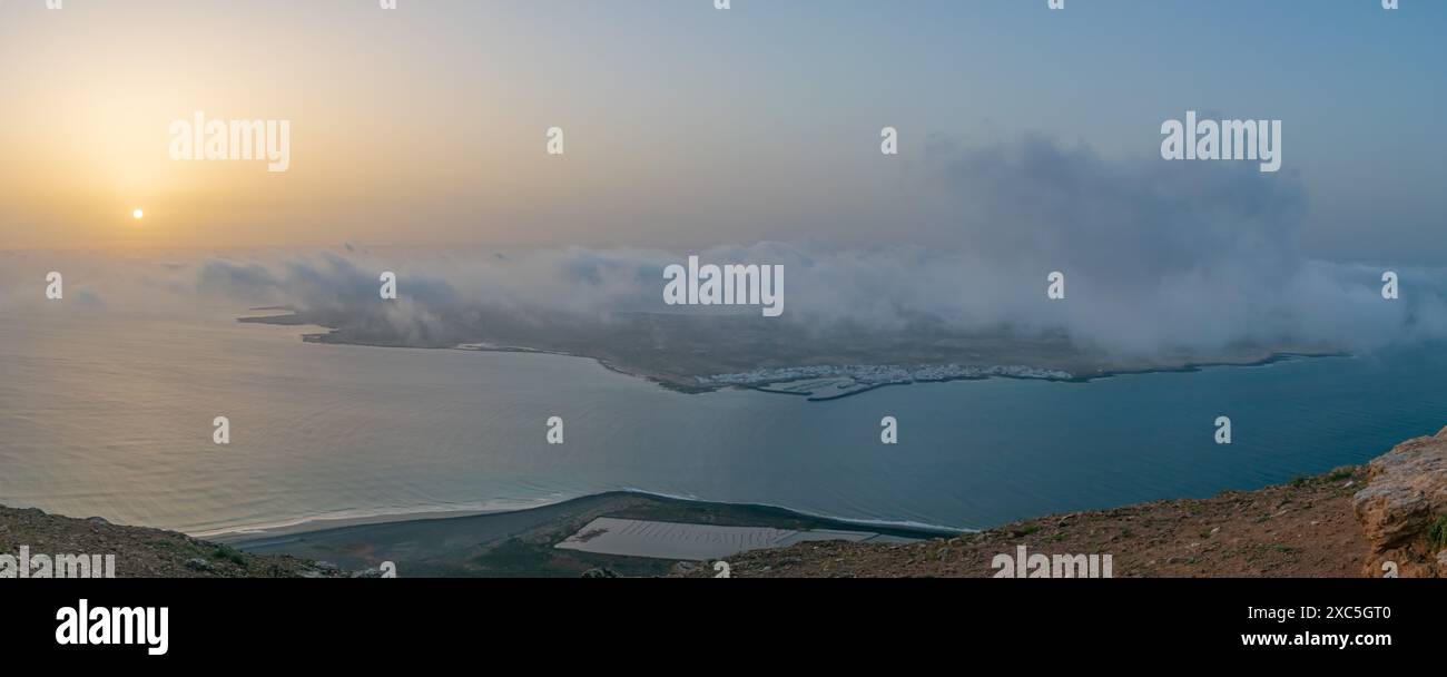 Panorama of coastal Sunrise Over Misty Harbor Stock Photo - Alamy