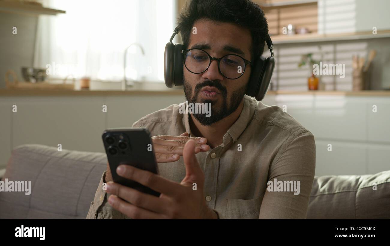 Carefree relaxed Arabian Indian man male ethnic guy in headphones ...