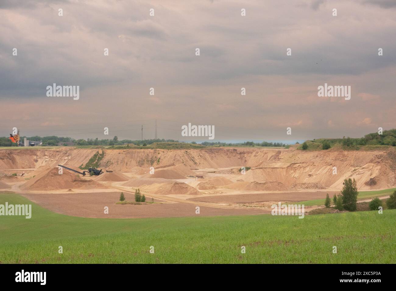 Extraction of light pink colored sand in a gigantic pit; a ruined ...