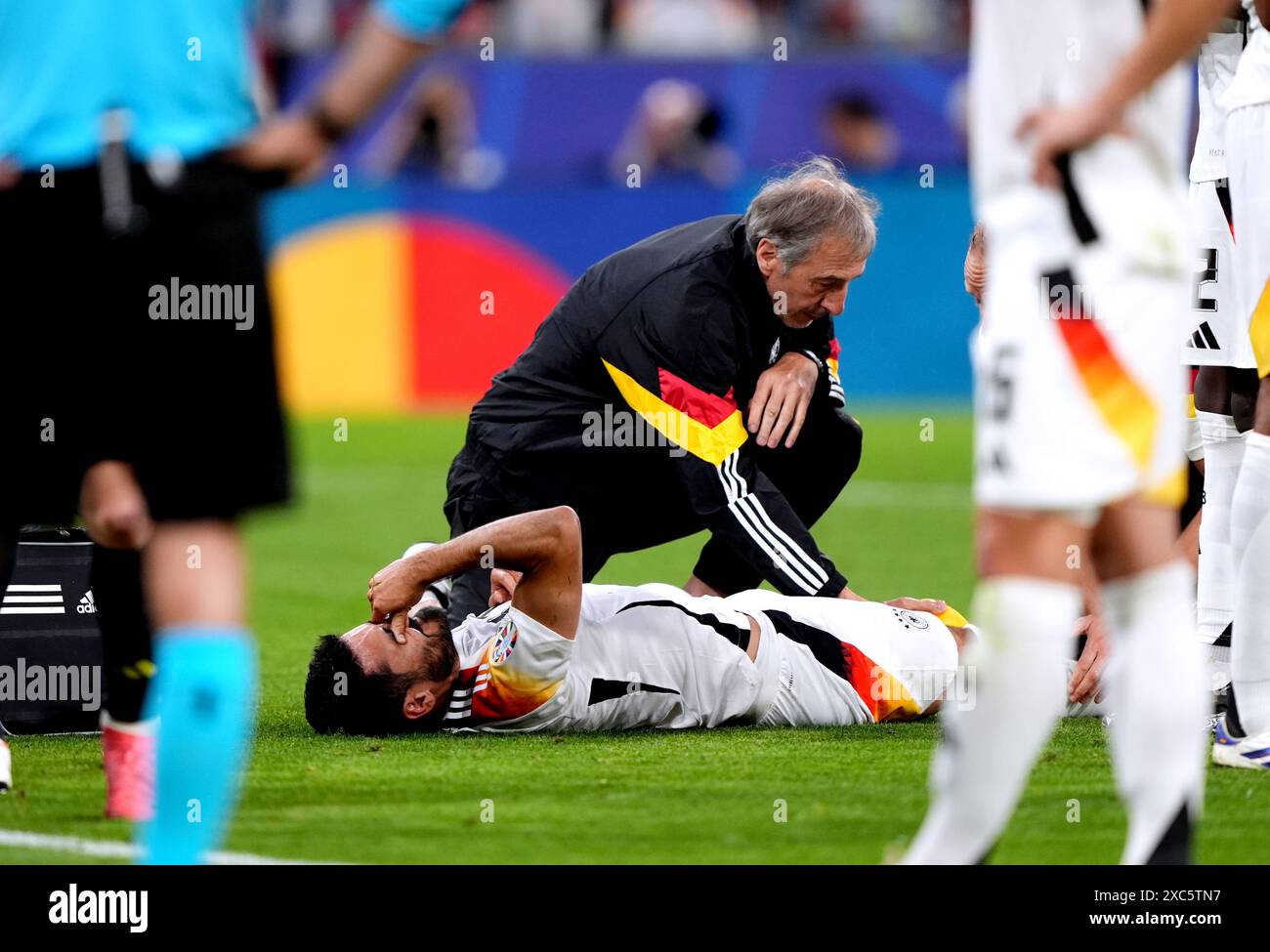 Germany's Ilkay Gundogan lies injured on the pitch after being fouled ...