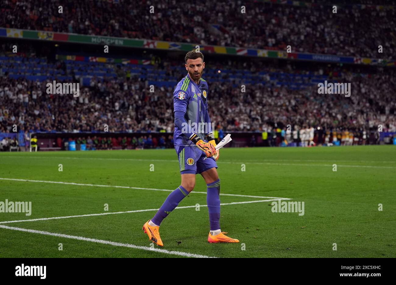 Scotland goalkeeper Angus Gunn holds a paper airplane thrown onto the ...