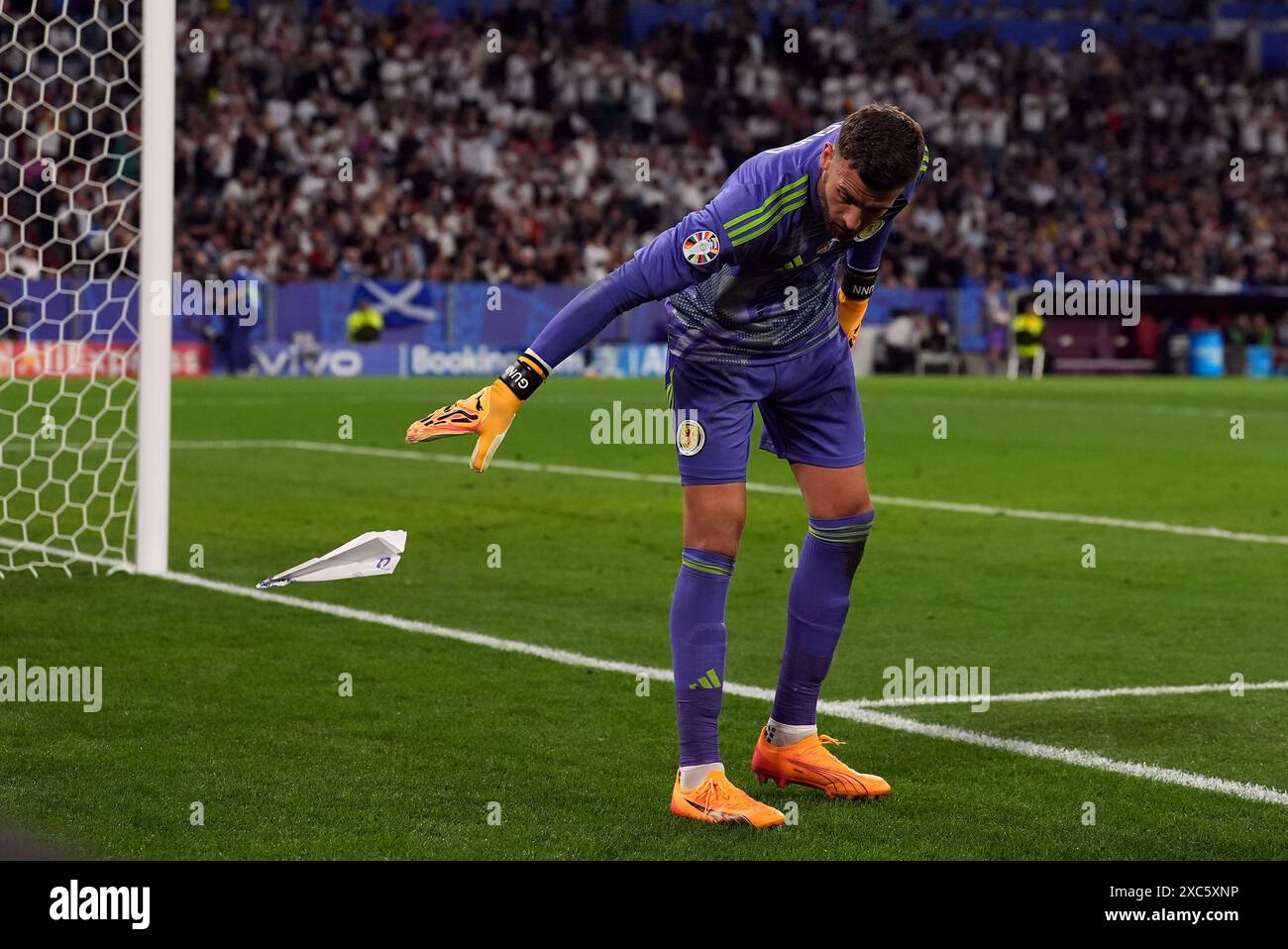 Scotland goalkeeper Angus Gunn removes a paper airplane thrown onto the ...