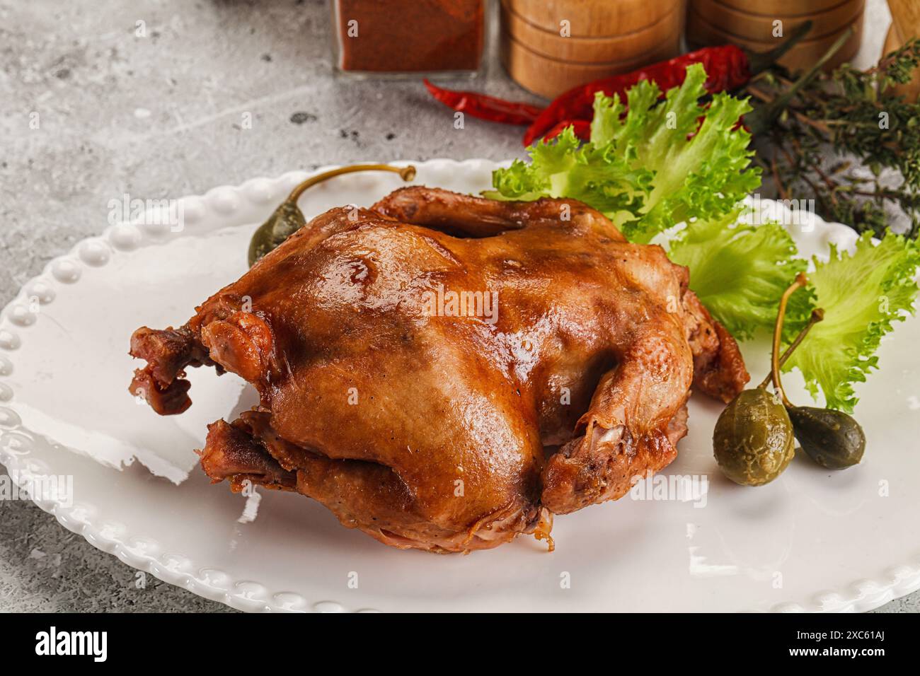 Baked whole small chicken with spices Stock Photo - Alamy