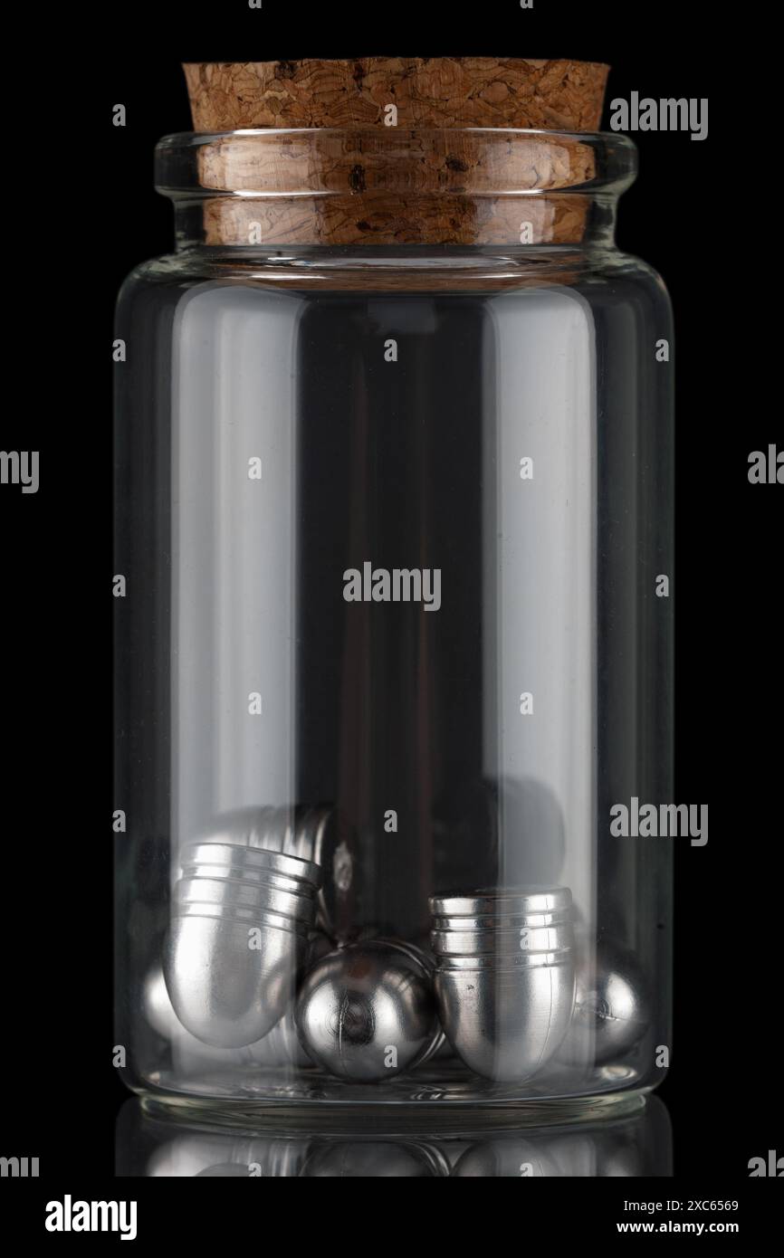 silver bullets for muzzle guns in apothecary glass jar on black ...