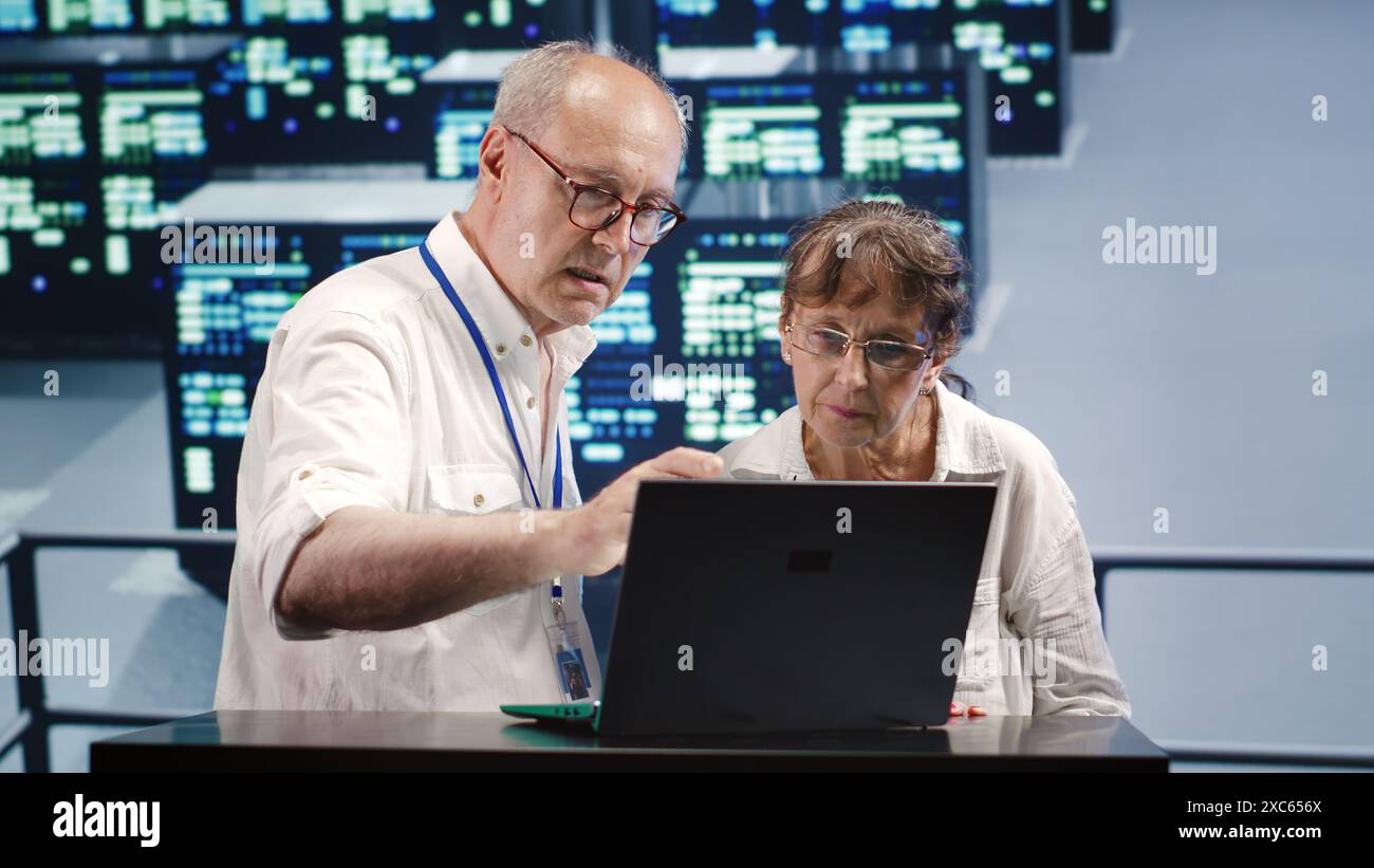 Octogenarian employees looking around innovative hi-res stock ...