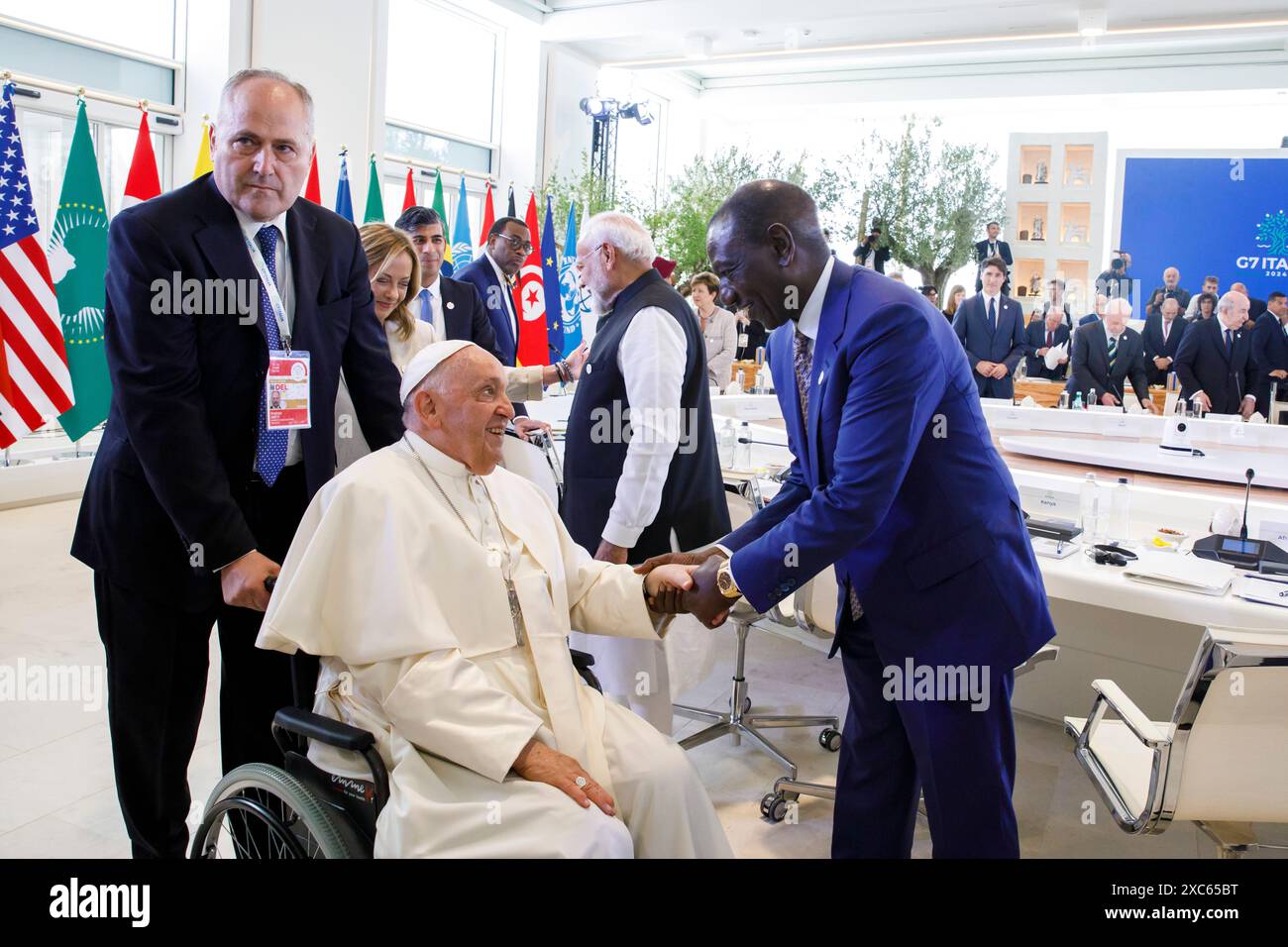 Apulia, Italy. 14th June, 2024. Pope Francis, left, greets Kenya ...