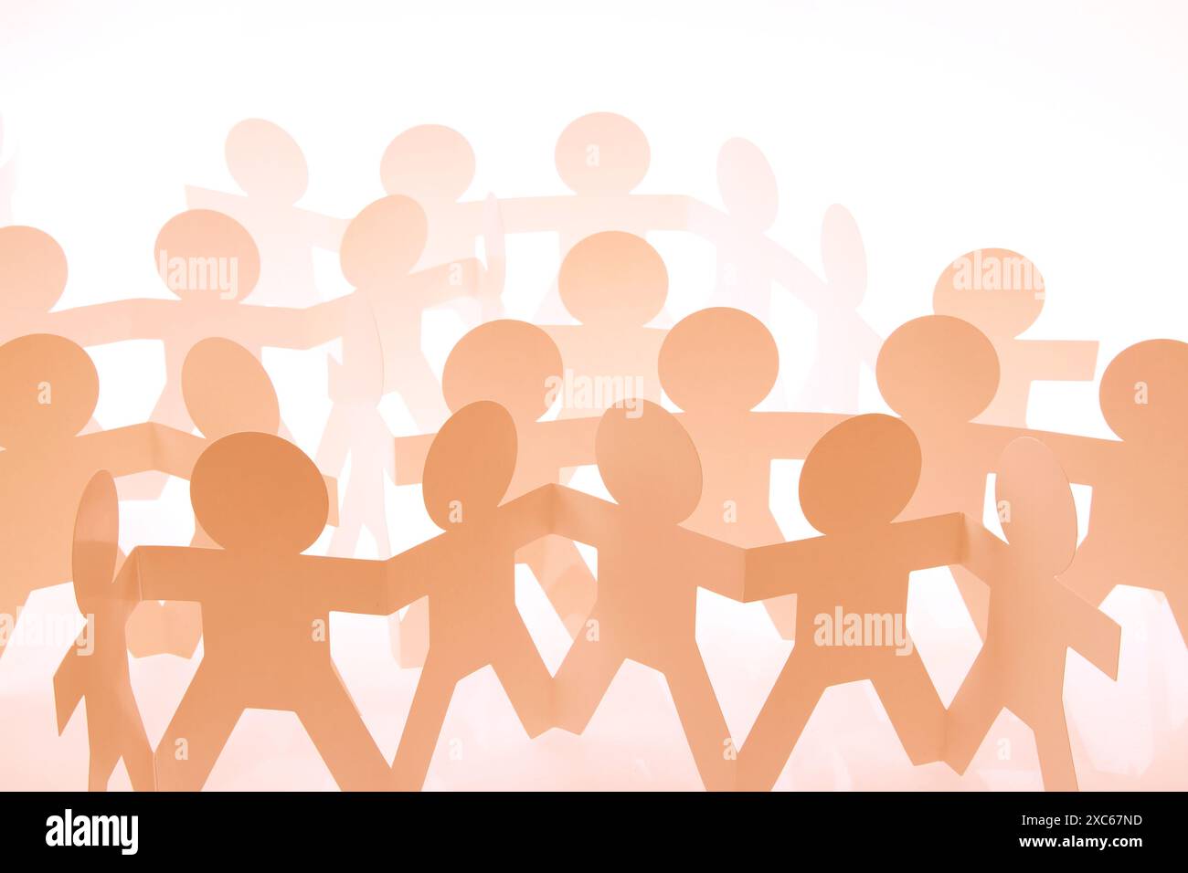 Team of paper chain people united together holding hands Stock Photo ...