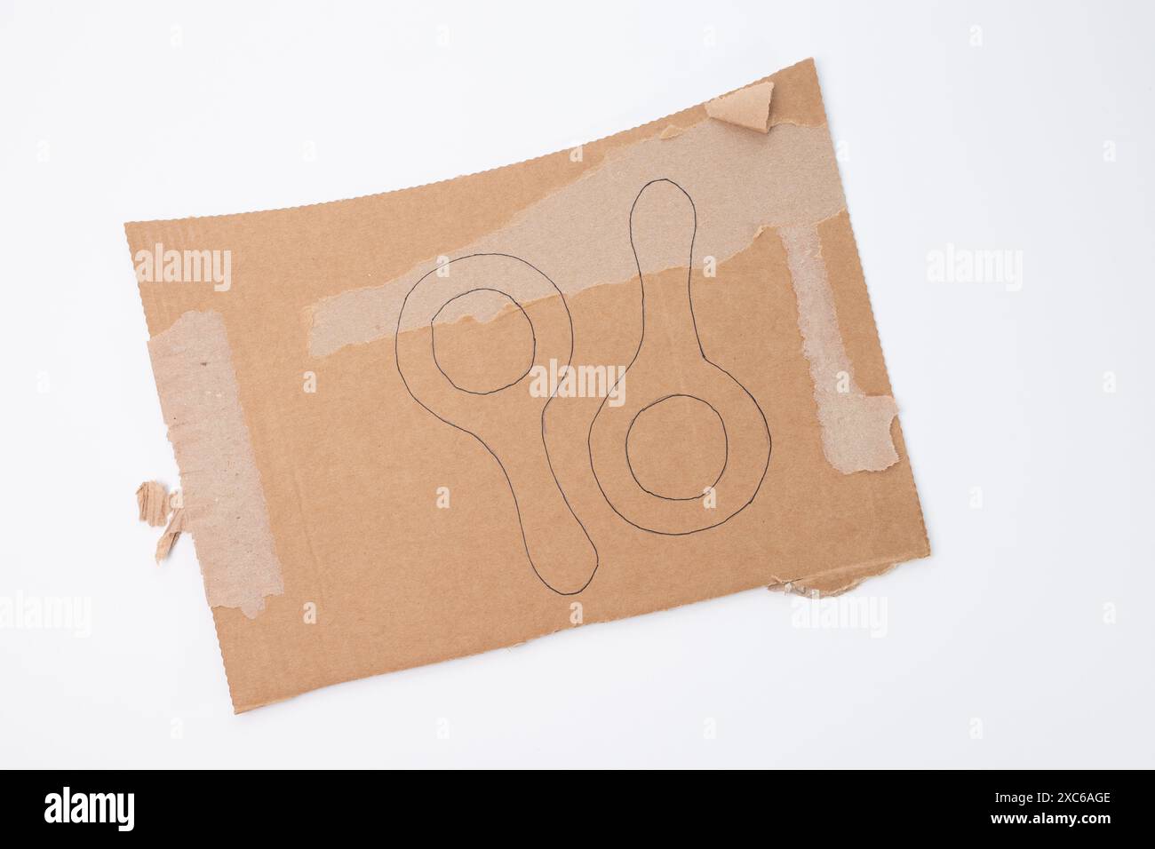 a piece of cardboard with a drawing a magnifying glass on it, process ...
