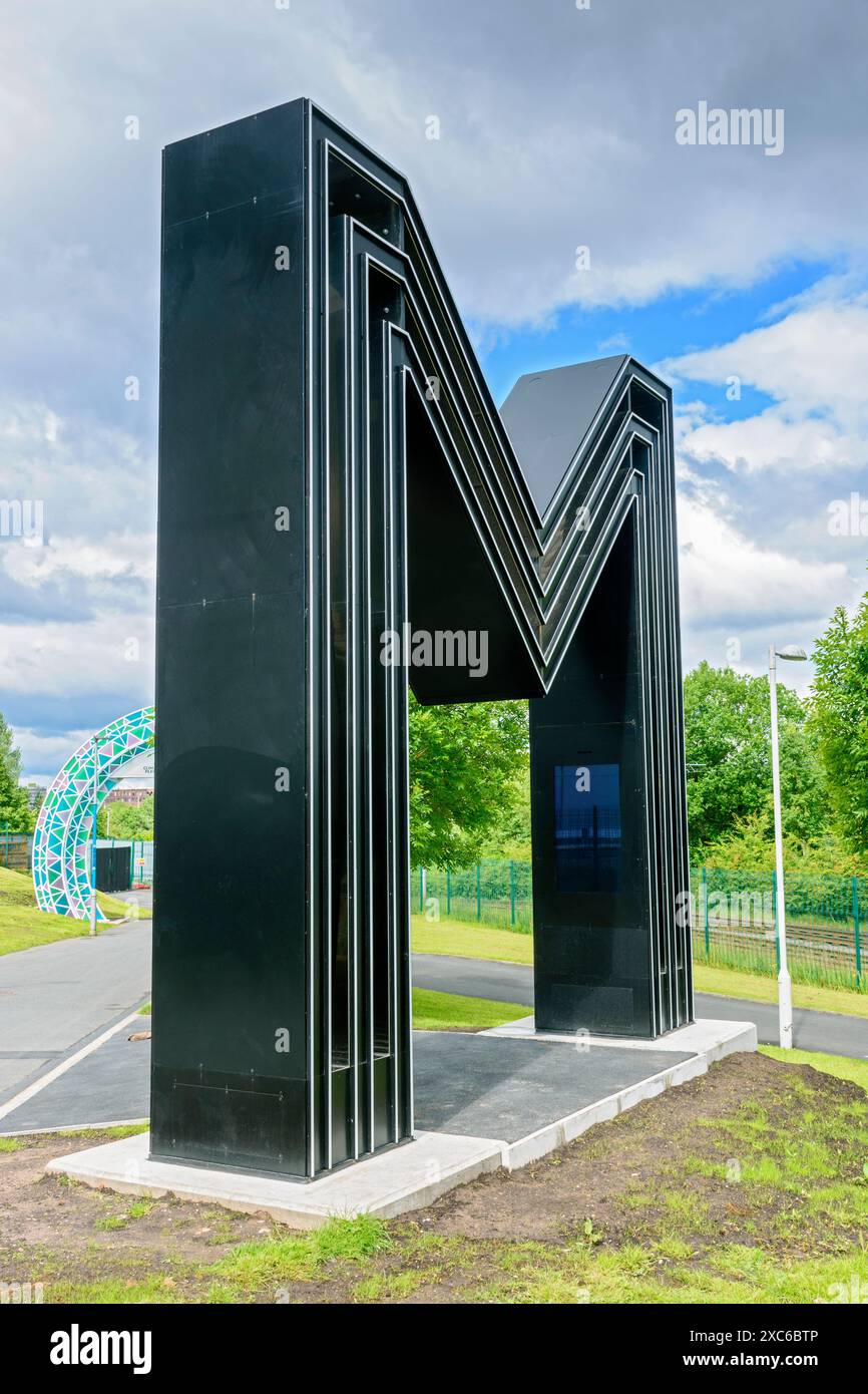 Giant M sculpture on the 'CityLink' walking route between the Etihad ...
