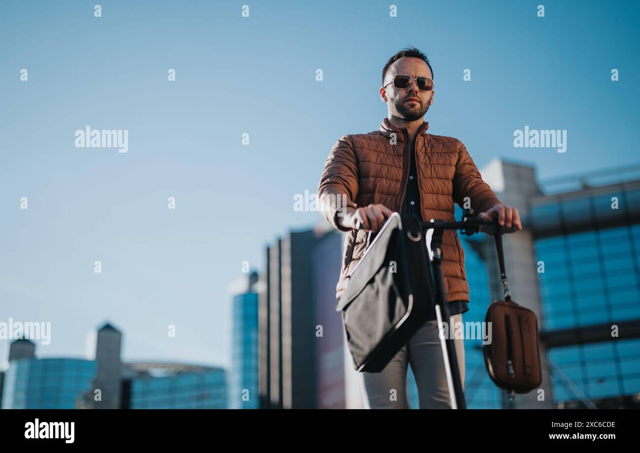 Modern businessperson commuting on electric scooter in the city Stock ...