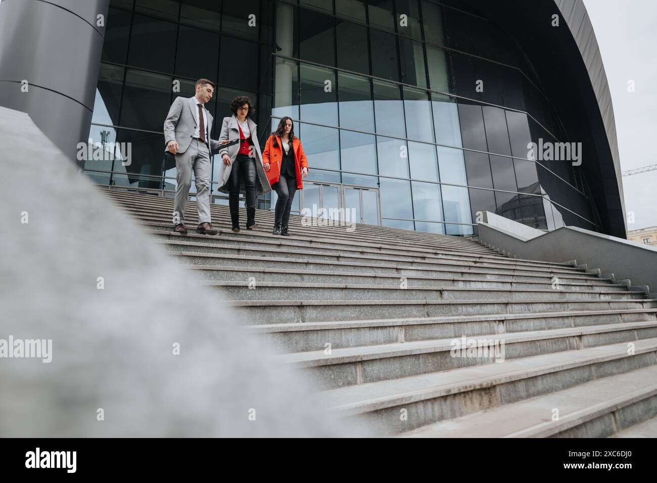 Confident business people walking down office steps on a busy day Stock Photo - Alamy