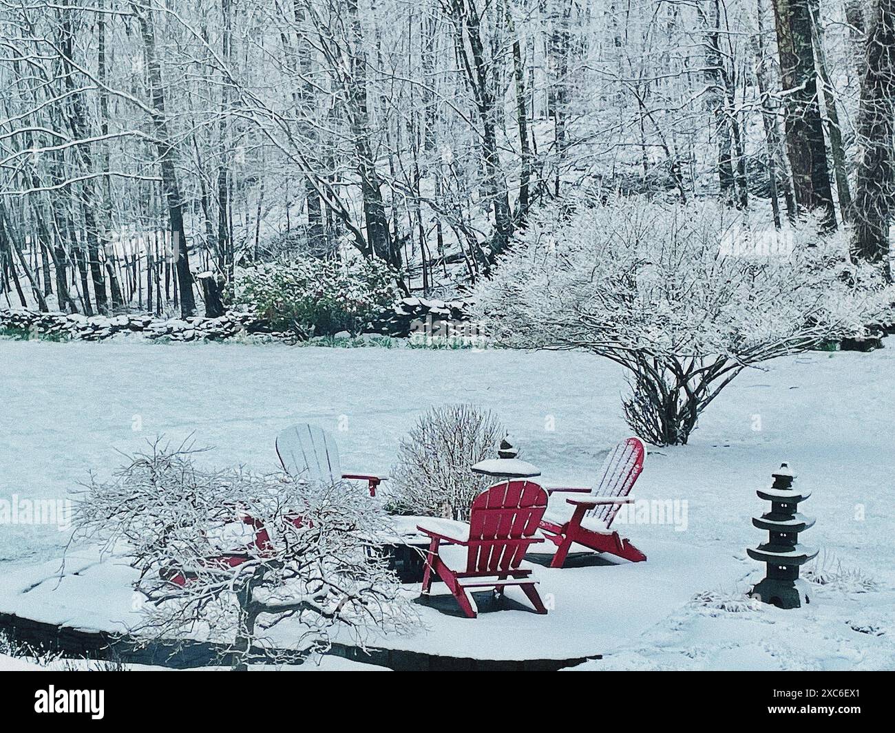 Snowy patio and landscape with red Adirondack chairs Stock Photo - Alamy