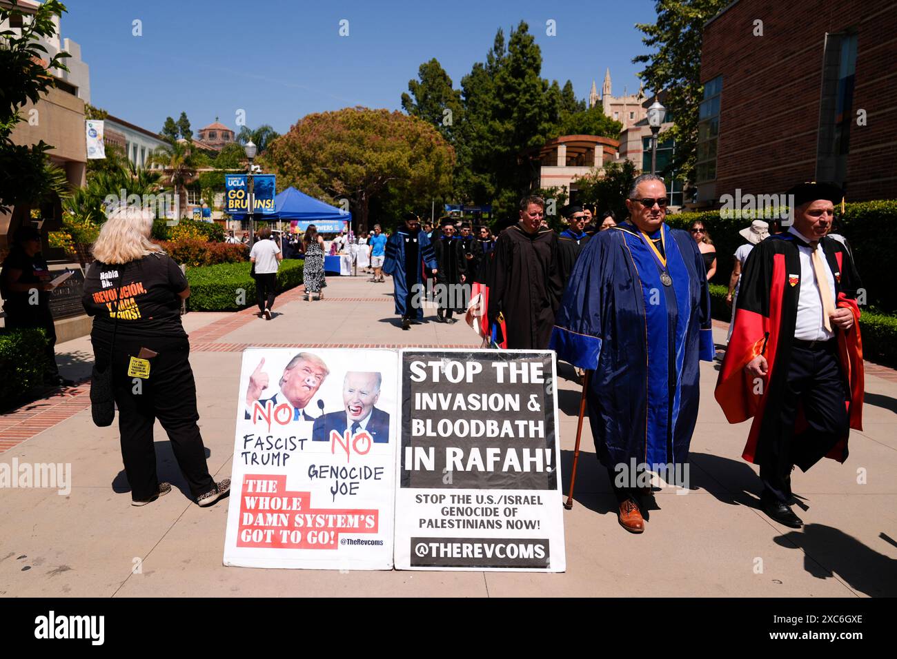 Faculty walk past a critical sign of the Israel Hamas war on the UCLA ...