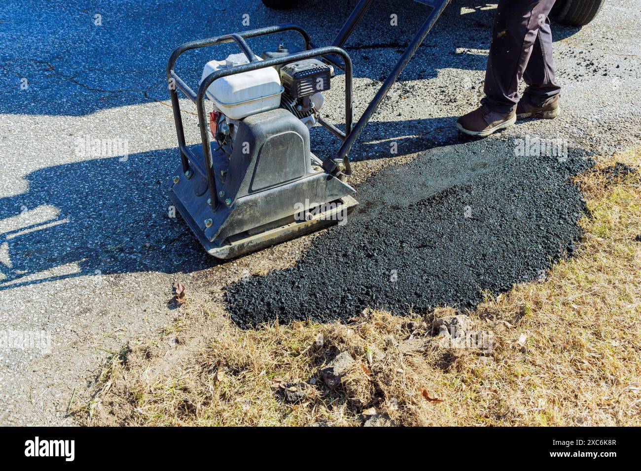 Parking lot repair job necessitates manual tamping compacting vibratory ...