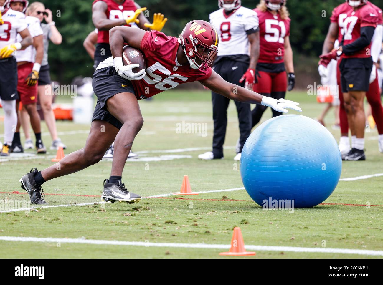 Washington Commanders defensive end Jalen Harris (56) performing drills ...