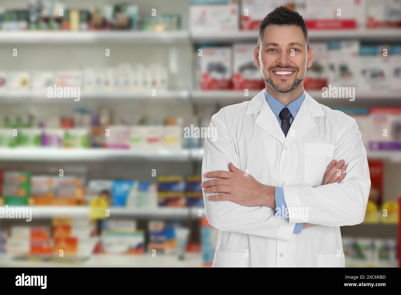Smiling positive male pharmacist hi-res stock photography and images ...