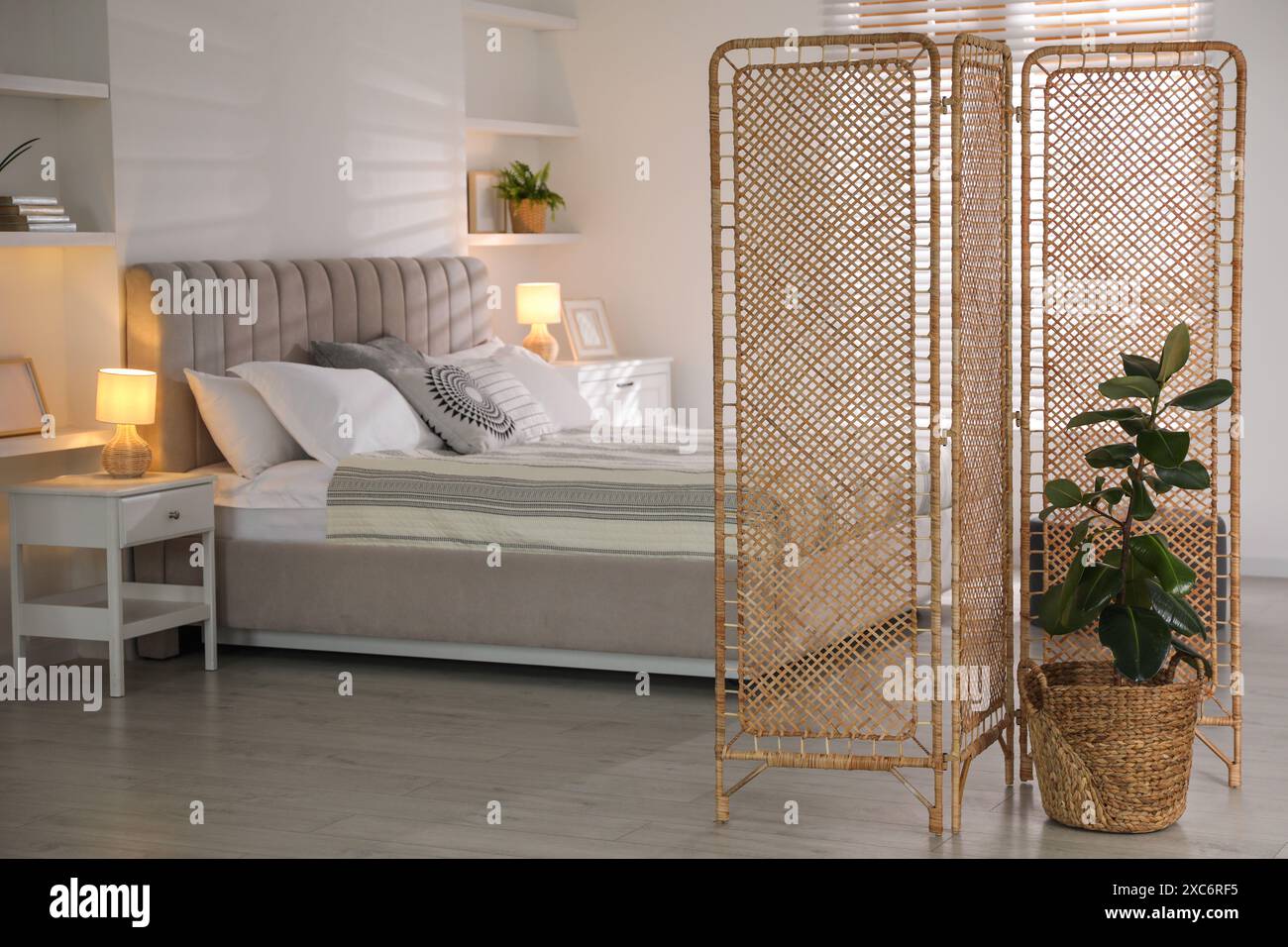 Folding screen and comfortable bed in bedroom. Interior design Stock ...